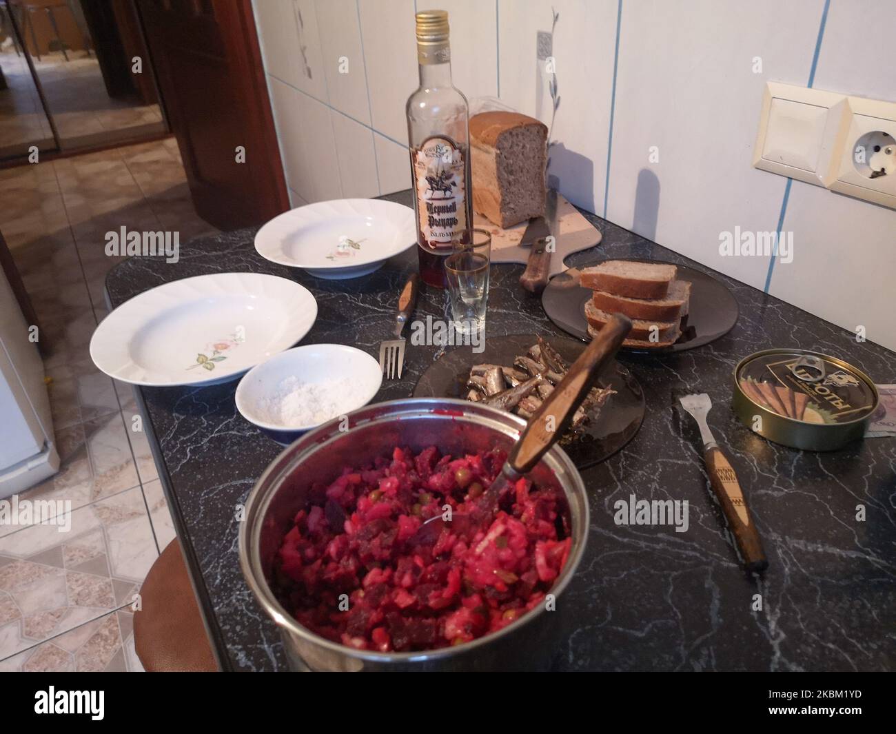 Traditional Russian dinner with a bread, herring, sprats, vegetable ...