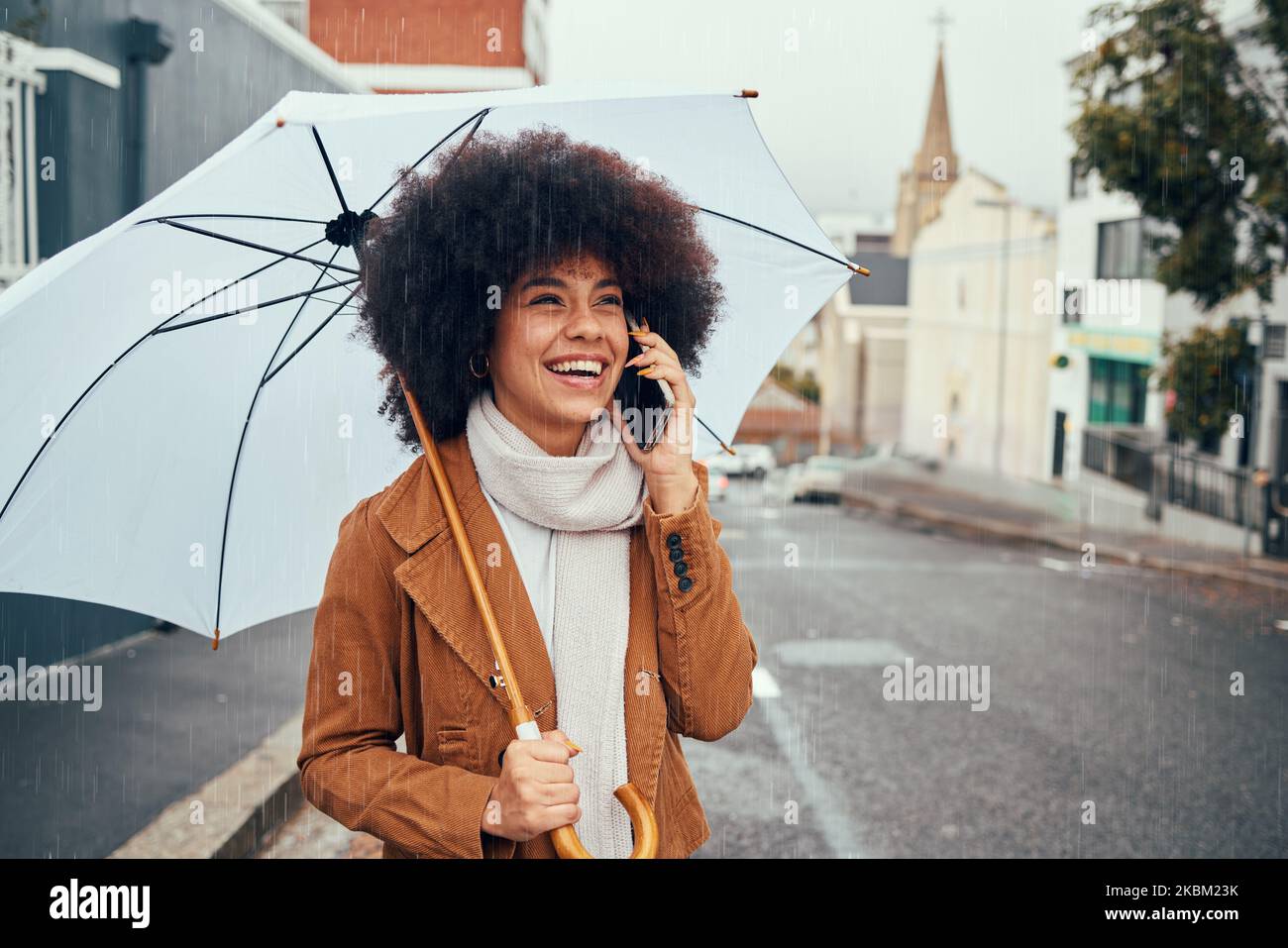 Phone call communication, rain and girl with umbrella talking ...