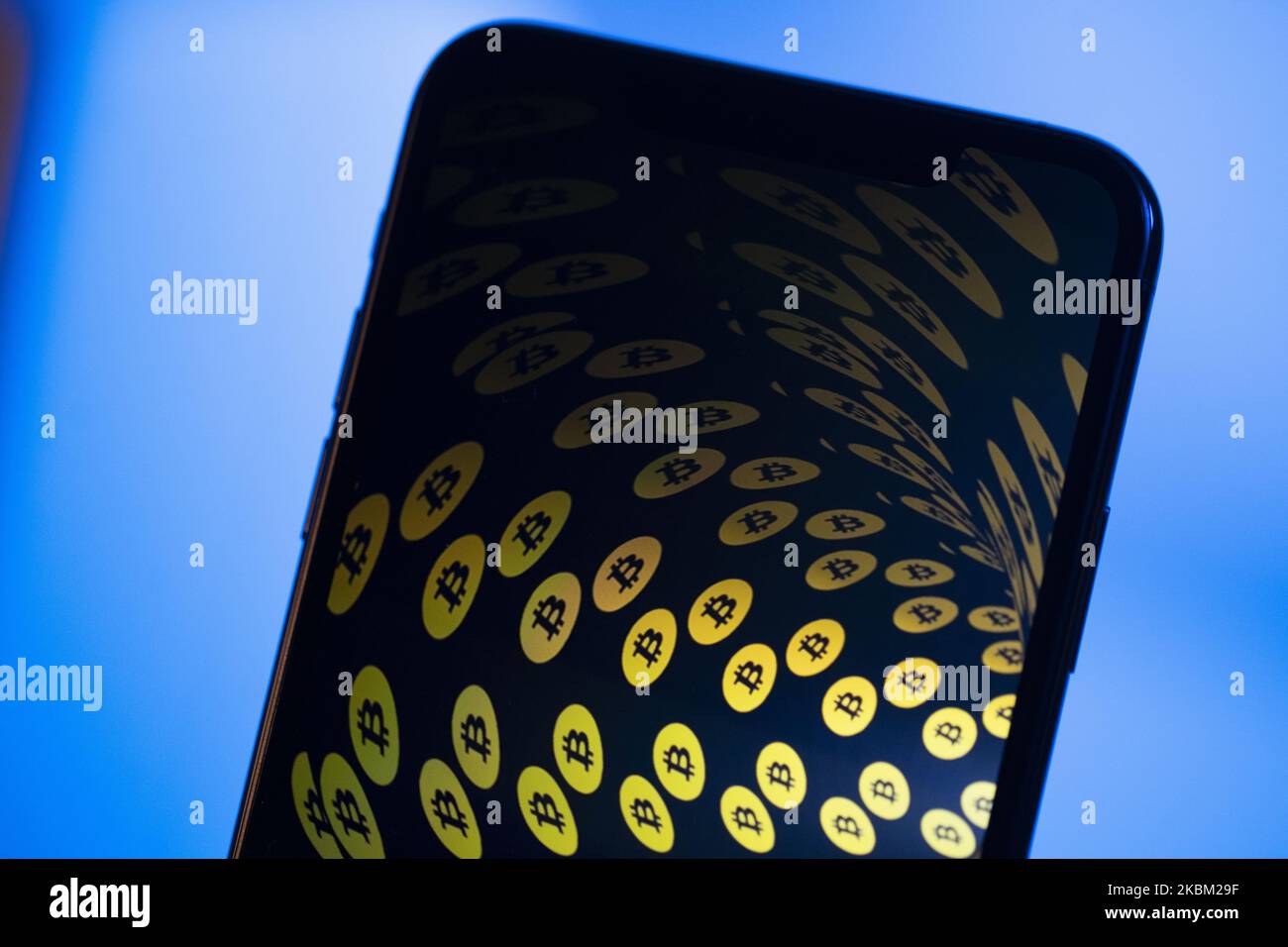 Bitcoin logos are seen on an iPhone 11 Pro Max in this illustration ...