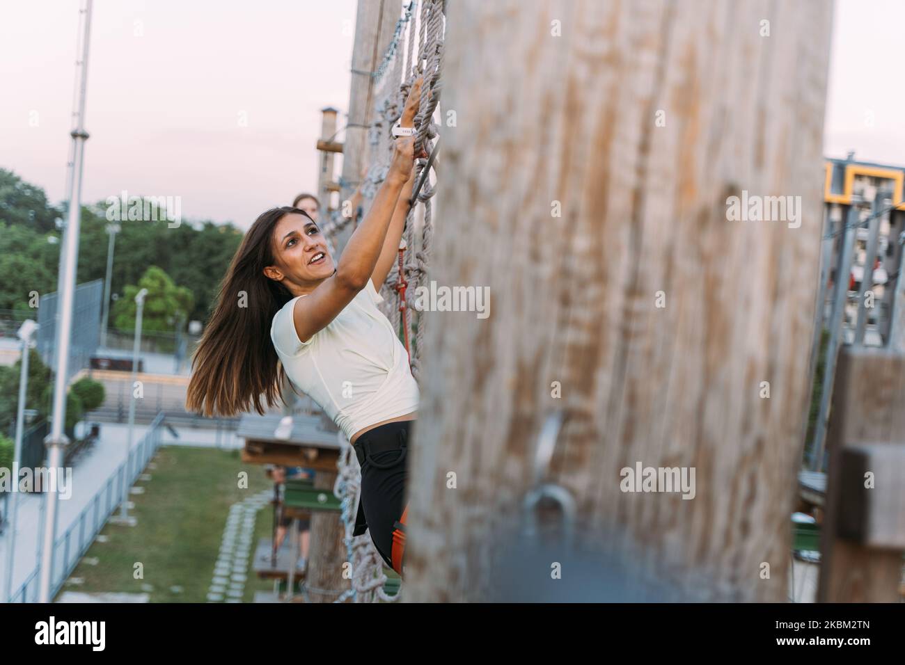 Athletic young girl going through the ropes in the adventure park Stock ...