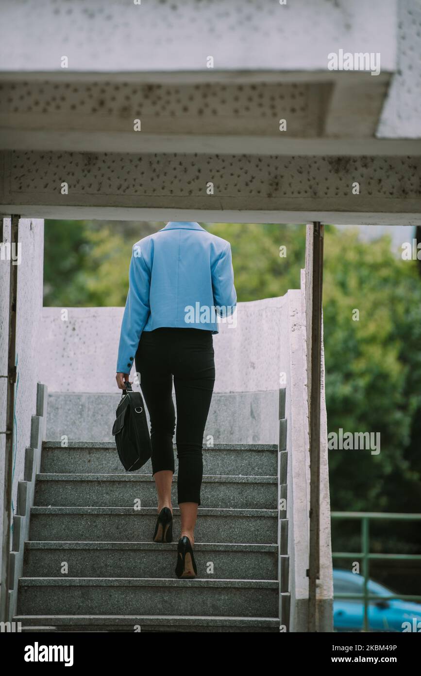Young worker going up stairs hi-res stock photography and images - Alamy