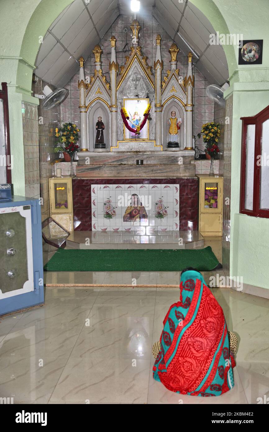 Tamil Catholic devotee offers prayers in the main shrine at the ...