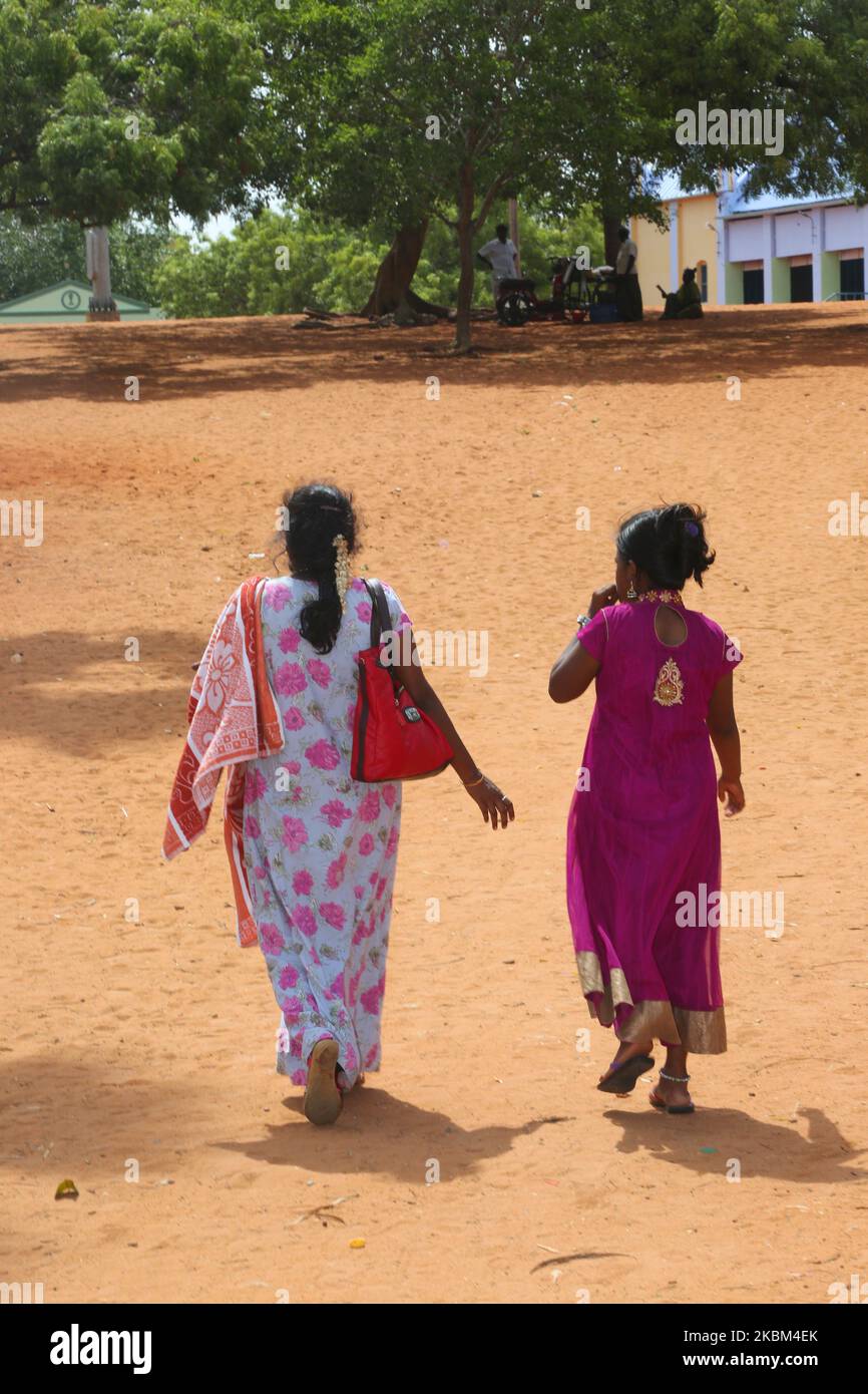 Tamil Catholic devotees walk along the grounds of the Athisaya Manal ...