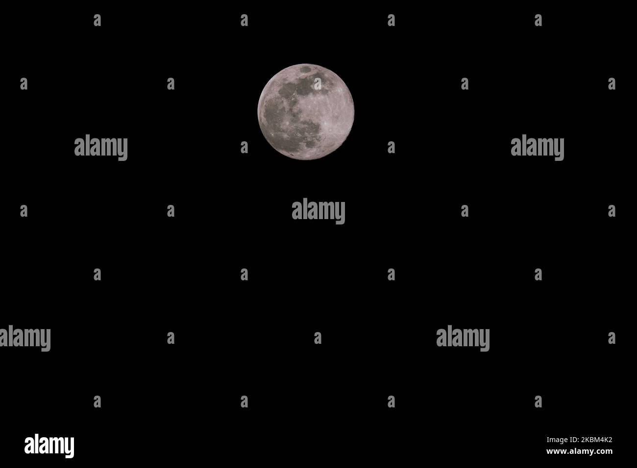 The full moon is pictured from Rome, Italy, early on April 7, 2020 ...