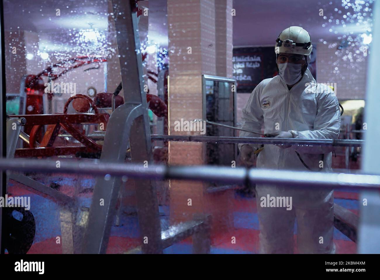 Member of white helmets sterilizes a bodybuilding gym in Idlib province ...