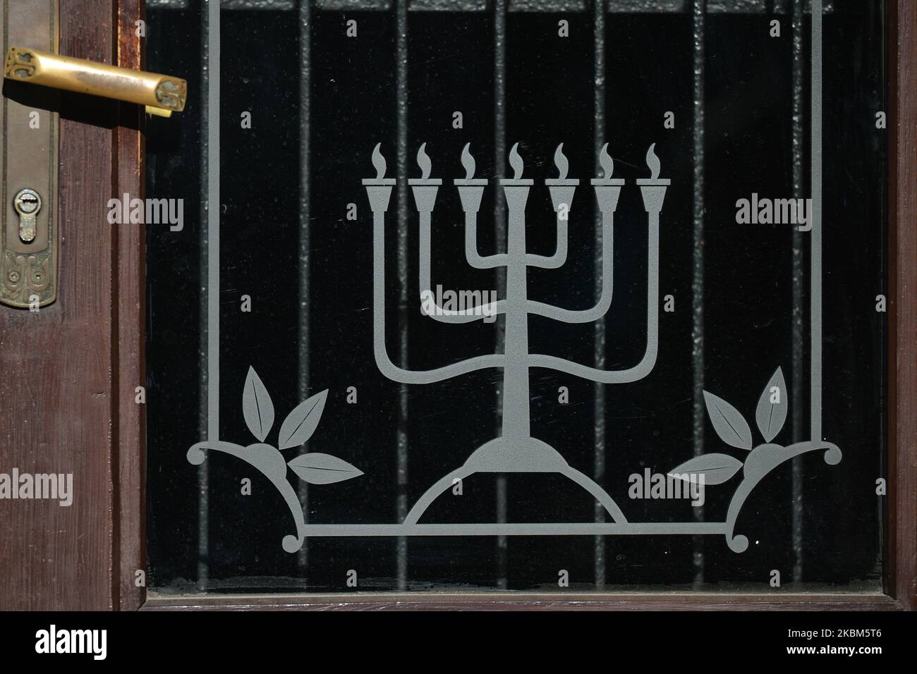 The menorah lamp seen in a closed restaurant's window in Kazimierz, a ...