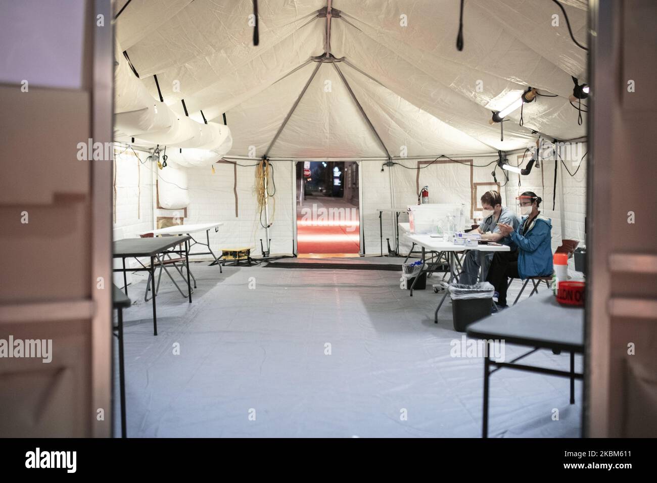 Hospital night staff sit at the screening tent outside of Norwegian ...