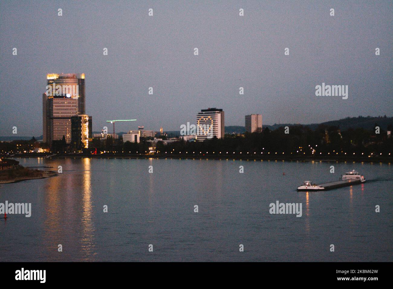 a cargo passes the rhine river while the Marriott Hotel Bonn with heart ...