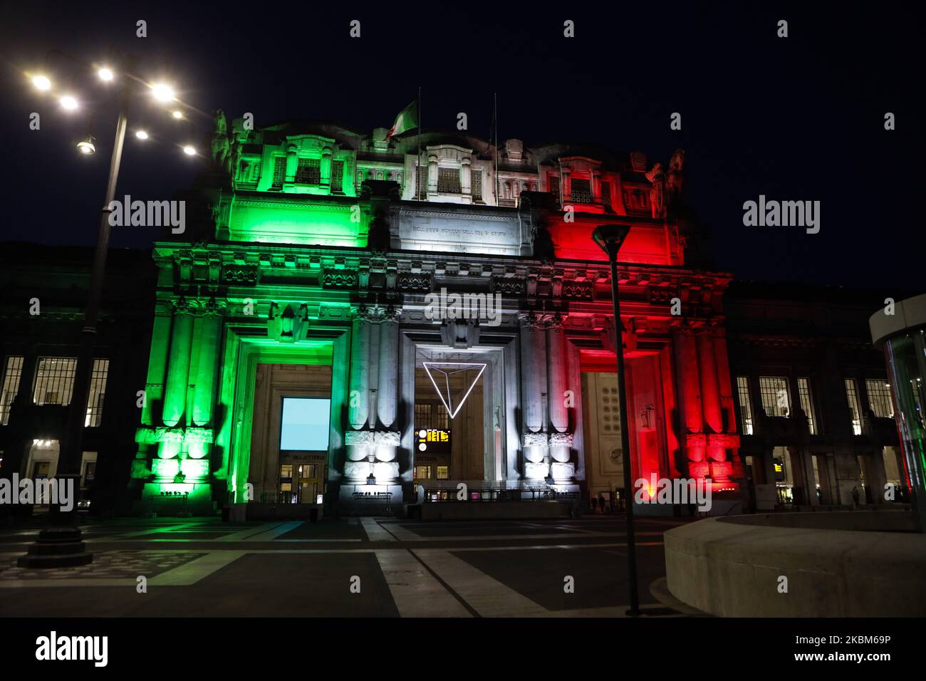 The facade of Milan Central Station illuminated with the Italian flag ...