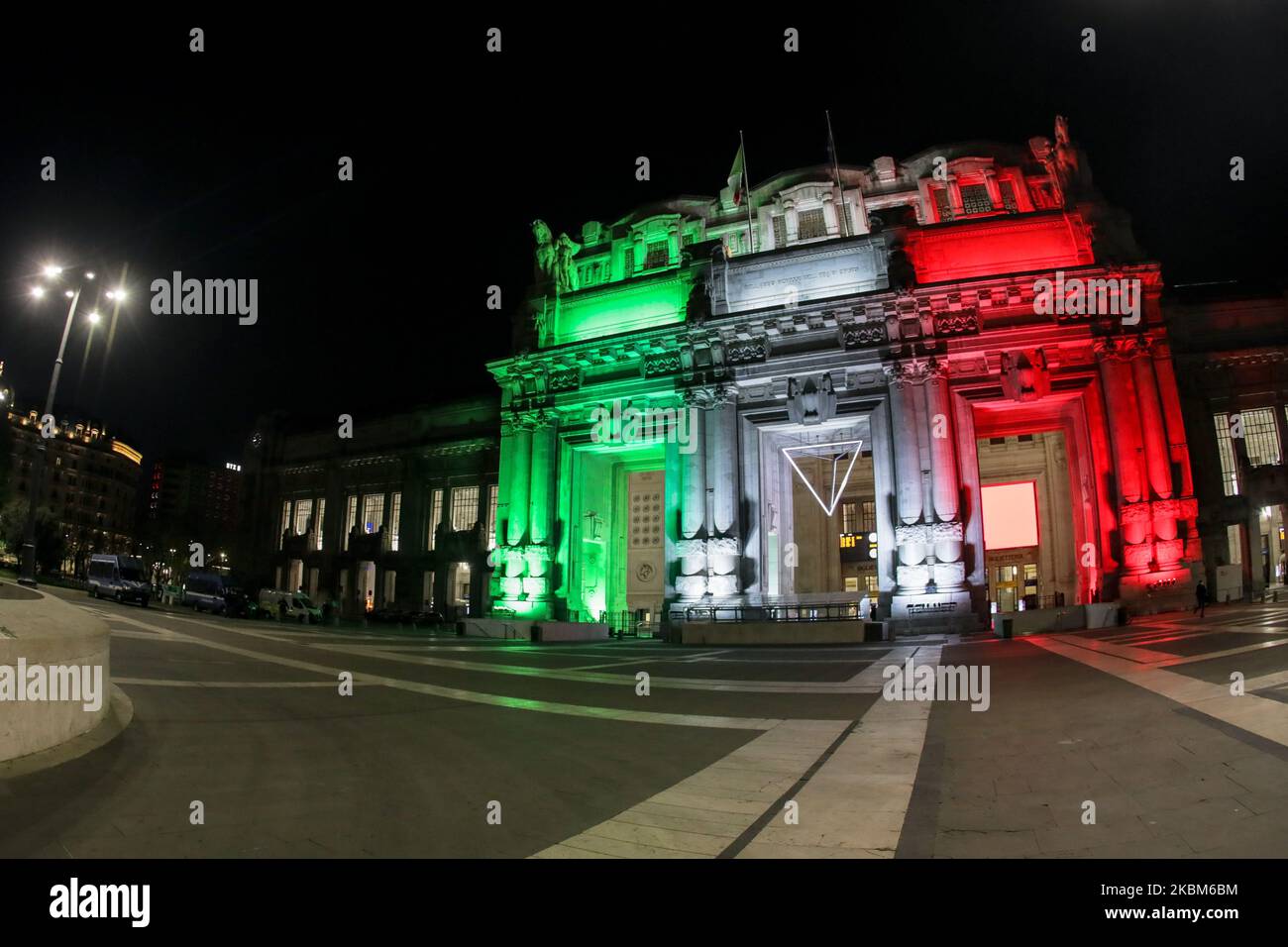 The facade of Milan Central Station illuminated with the Italian flag ...