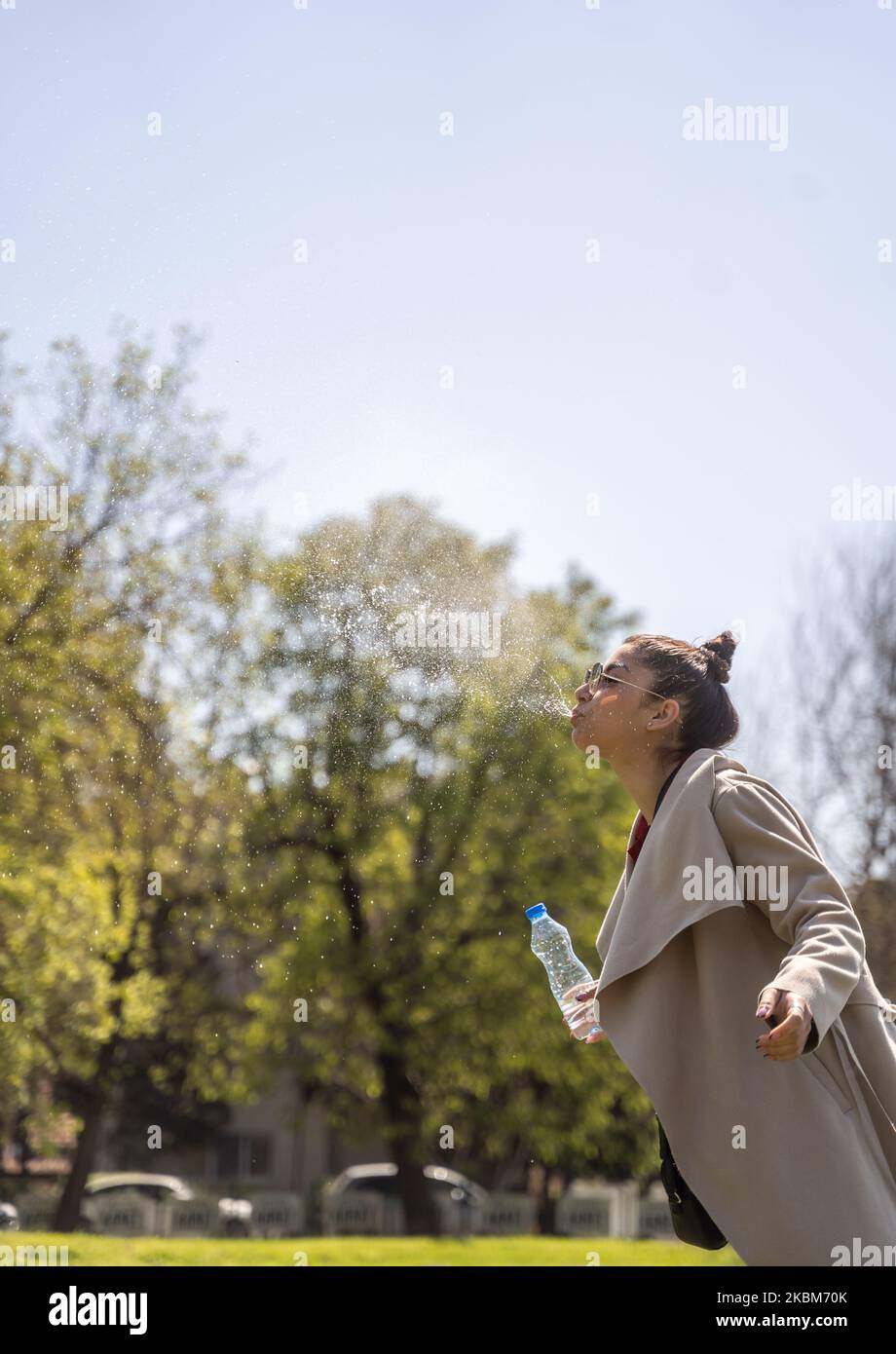 Young crazy girl spitting water from her mouth in the park Stock Photo ...