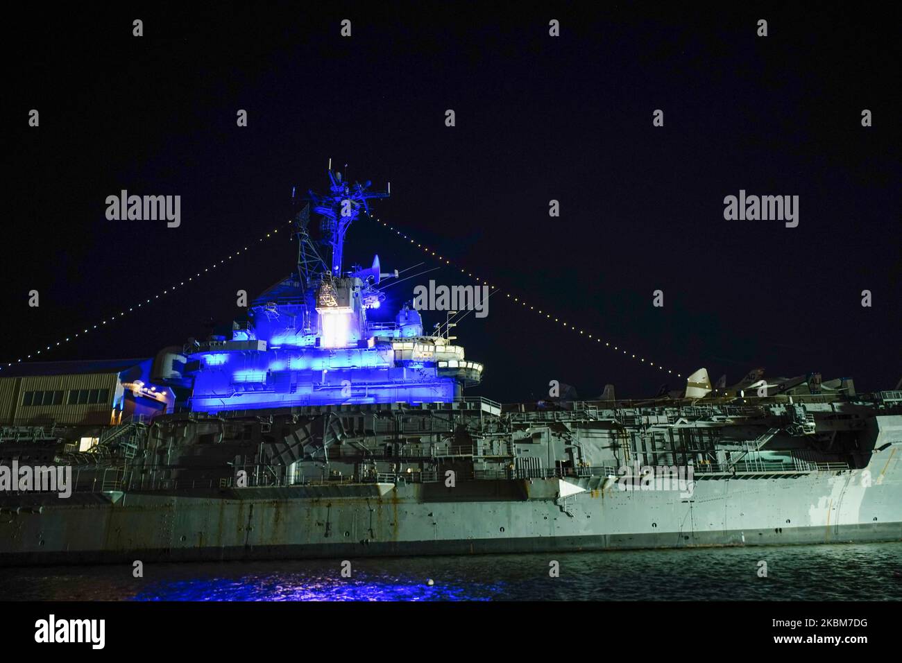 USS Intrepid is seen with blue lights on April 9, 2020 in New York City ...