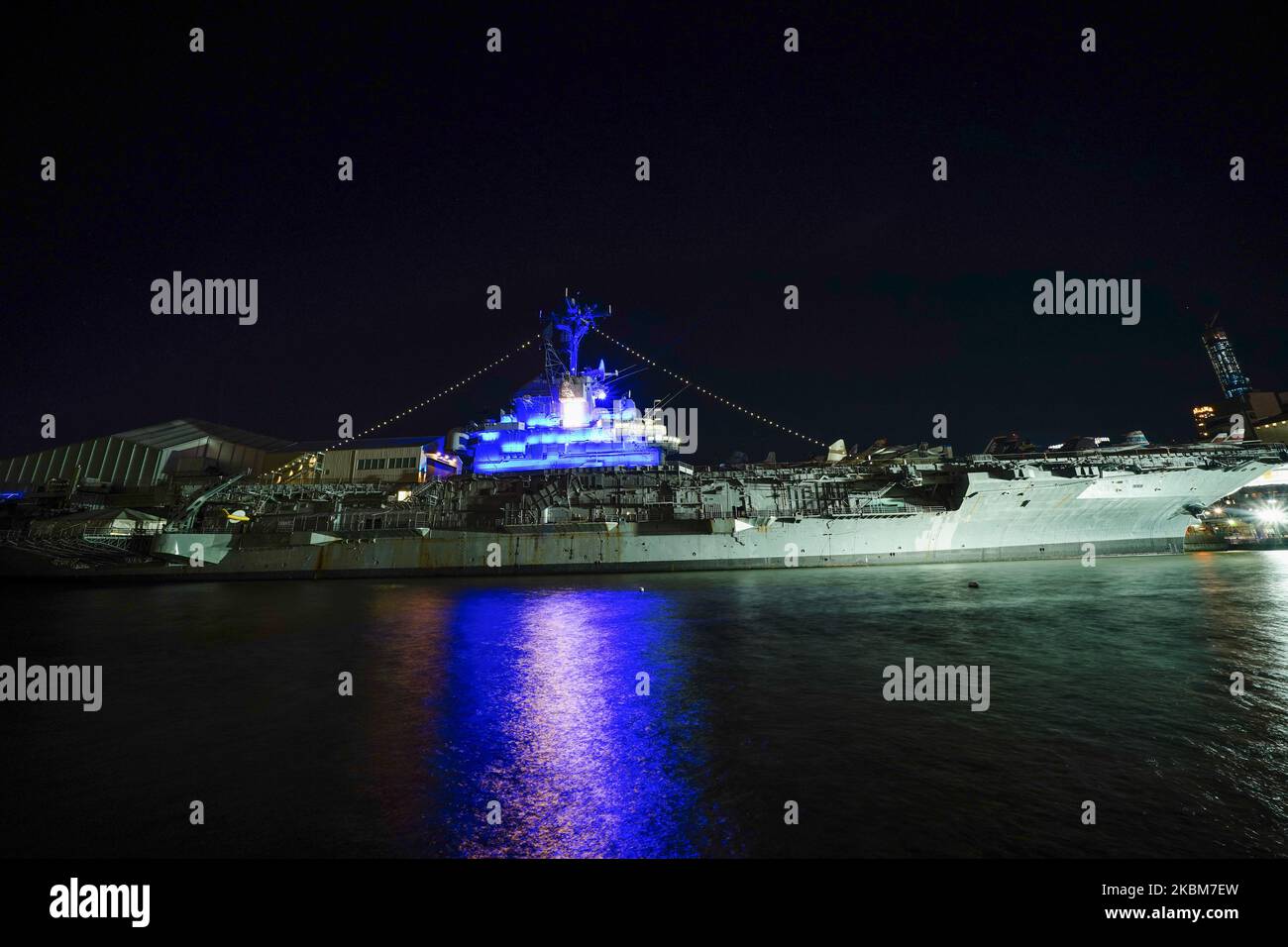 USS Intrepid is seen with blue lights on April 9, 2020 in New York City ...