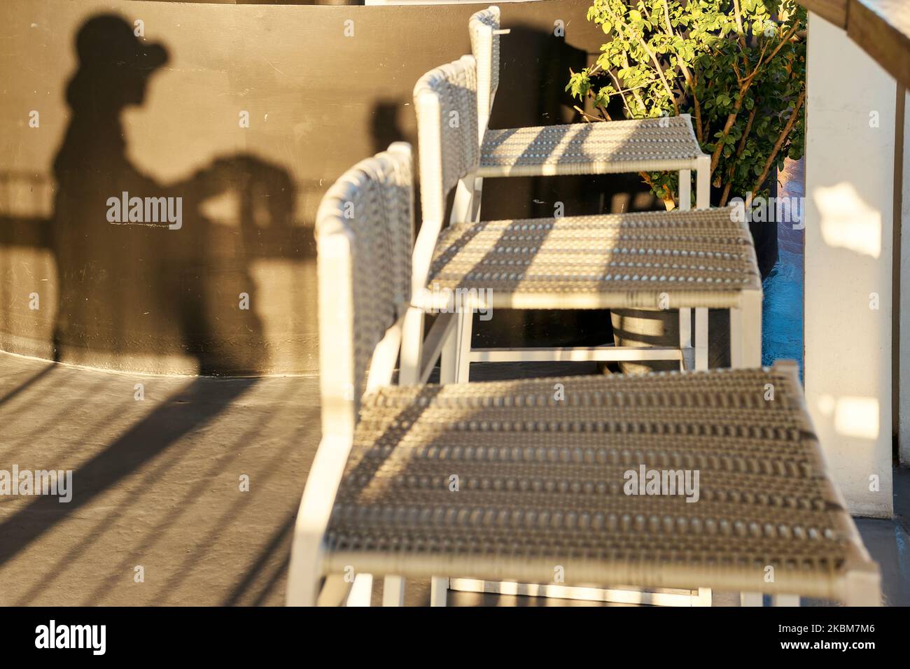 Shadow of a woman and empty chairs Stock Photo - Alamy
