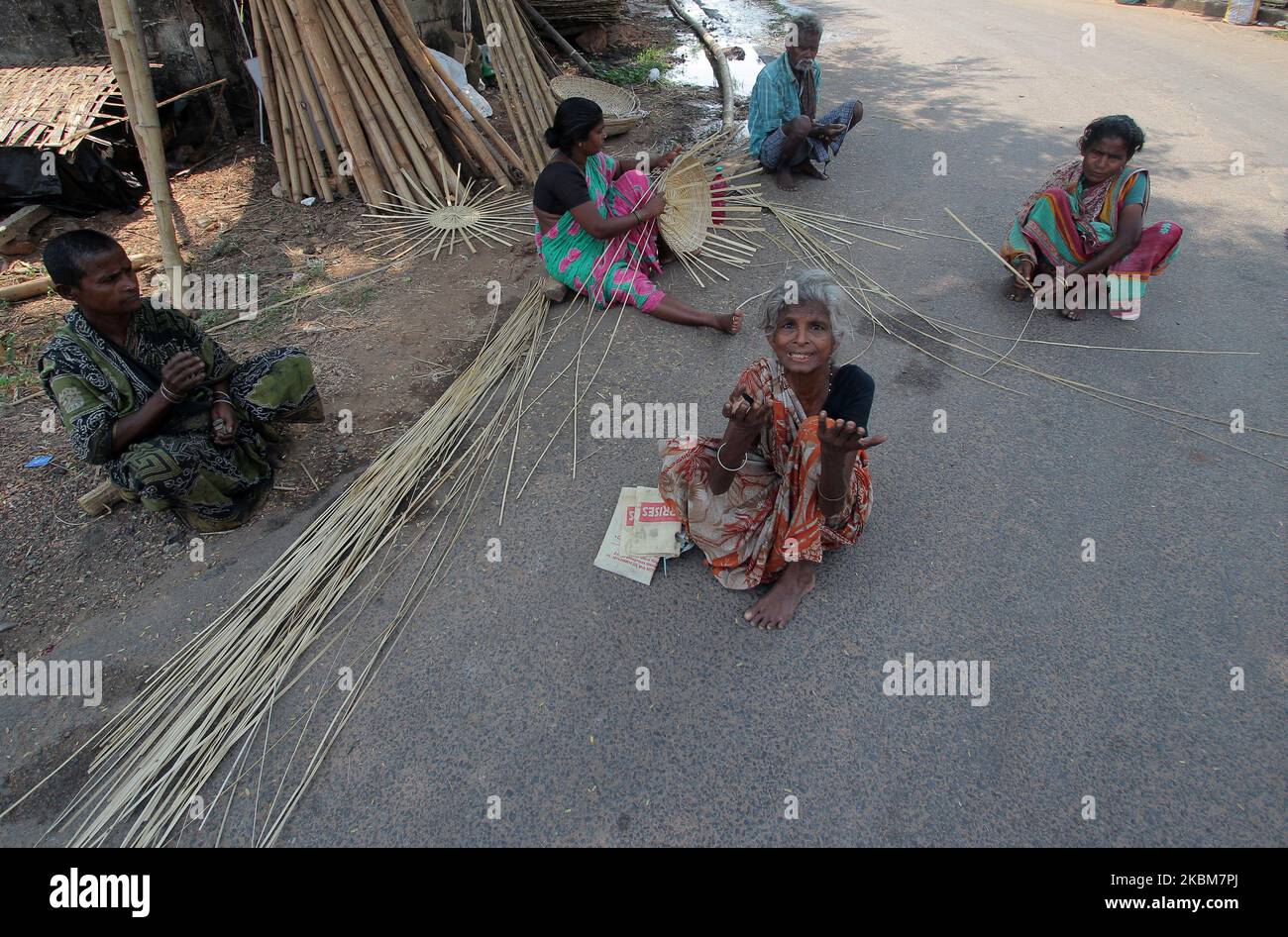 Slum dwellers are seen at their living slum as they are busy in their ...