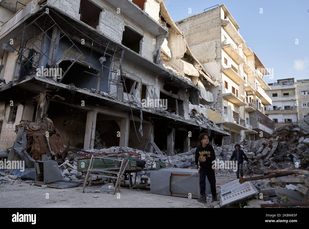A picture taken on April 10, 2020, shows Syrian children walk past the ...
