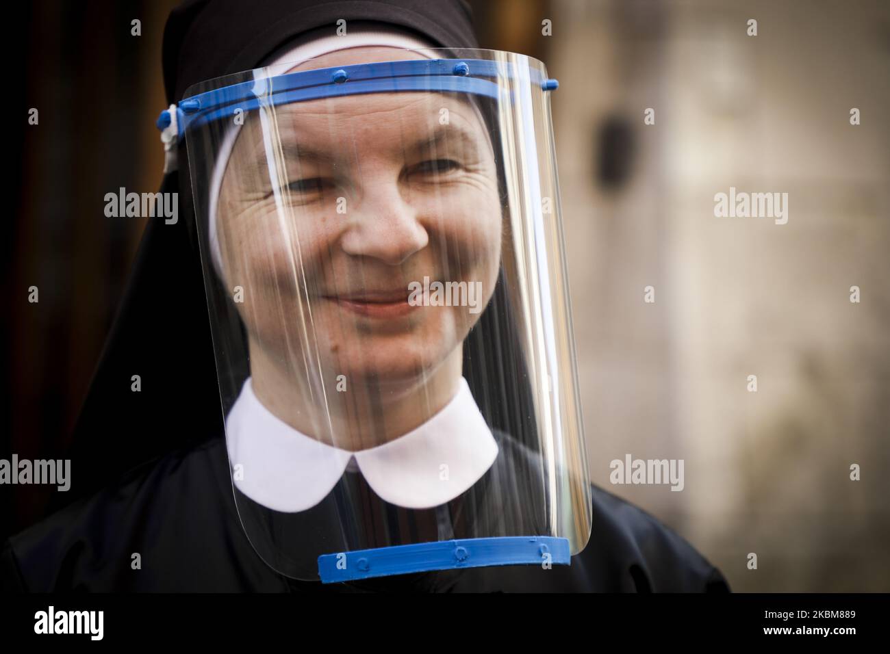 A nun wearing a protective face shield is seen while Sisters Canonesses ...