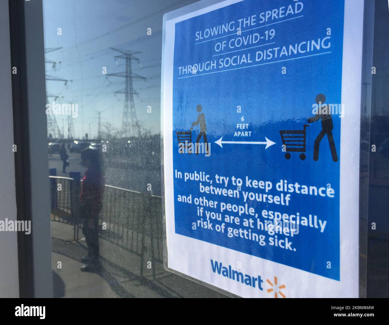 Sign promoting social distancing (physical distancing) at a Walmart ...