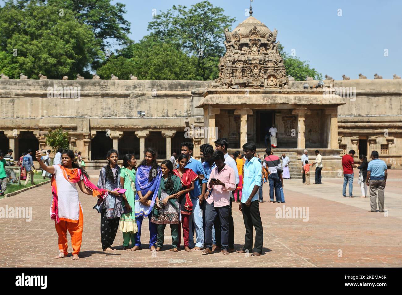 Group of Indian tourists take a selfie at the Brihadeeswarar Temple ...