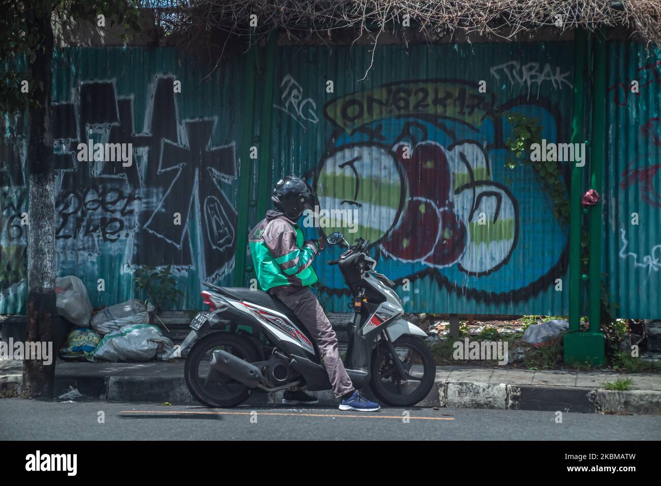Grab bike driver sits on his motorcycles in Yogyakarta, Indonesia, on ...