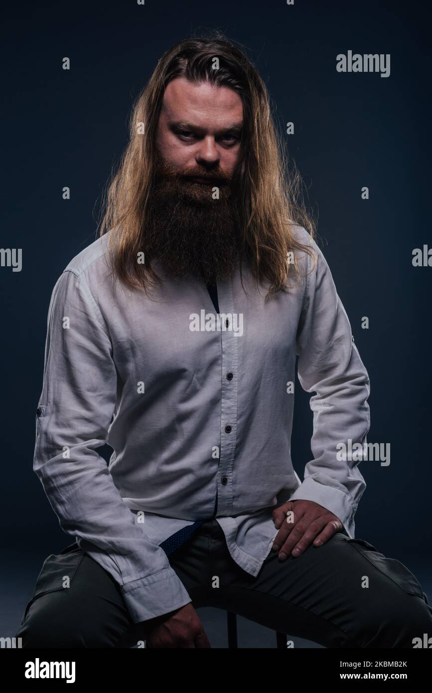 Close up portrait of handsome manly guy with beard posing in studio on ... Close up portrait of handsome manly guy with beard posing in studio on ...