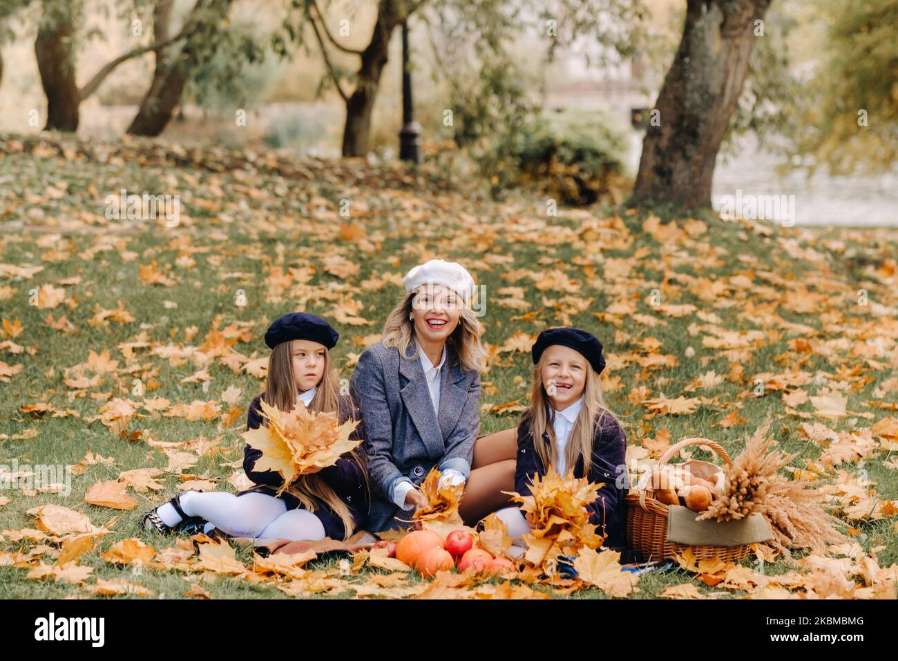 A big family on a picnic in the fall in a nature park. Happy people in ...