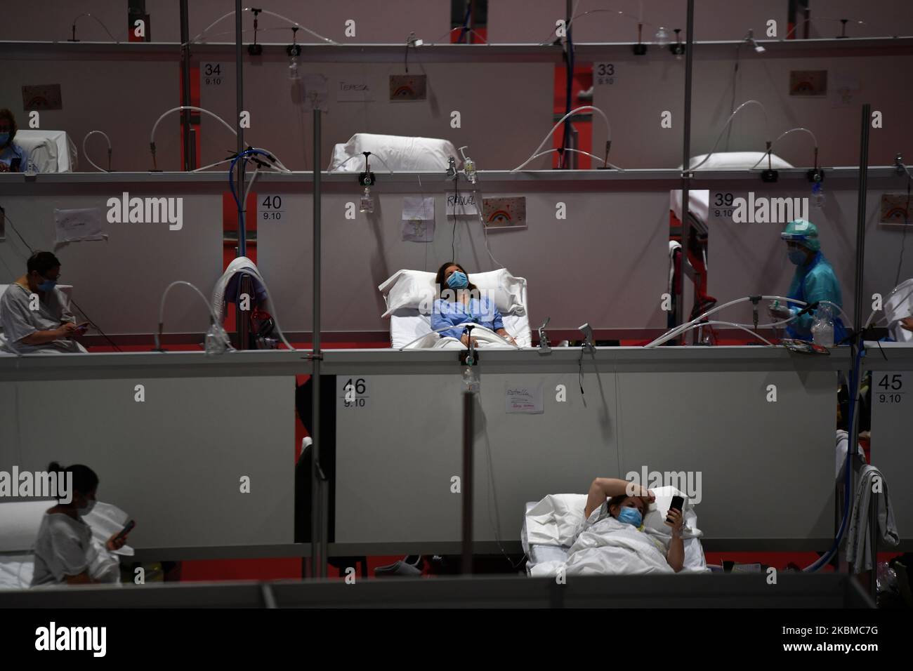 Patients rest in their beds at the temporary hospital for COVID-19 ...