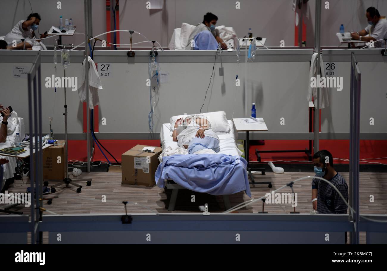 Patients rest in their beds at the temporary hospital for COVID-19 ...