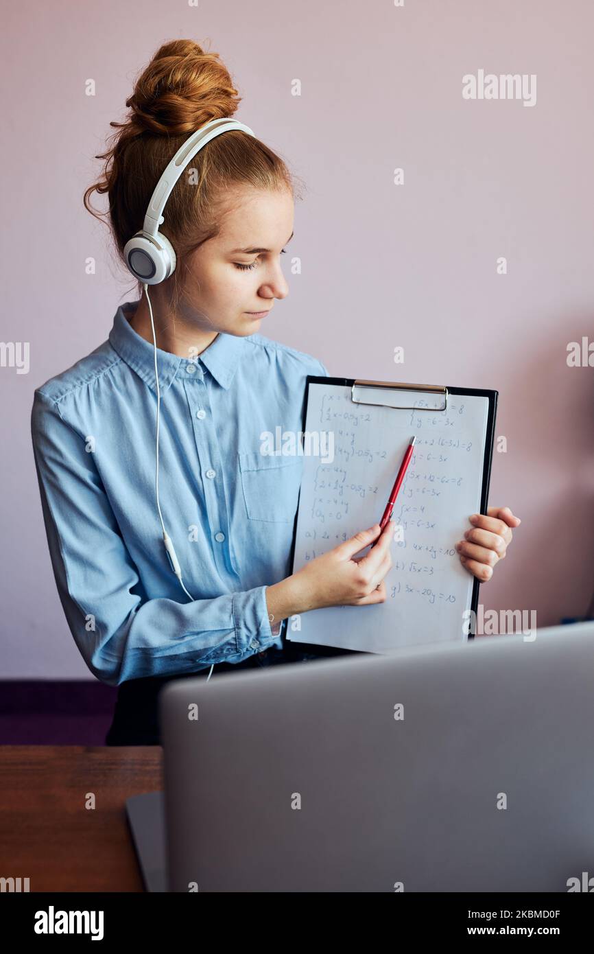 Young woman student showing homework, having classes, learning online ...