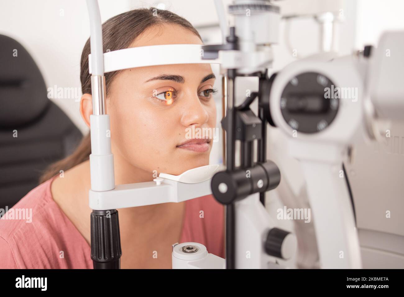 Vision, ophthalmology and woman in eye exam with light on iris at eye ...