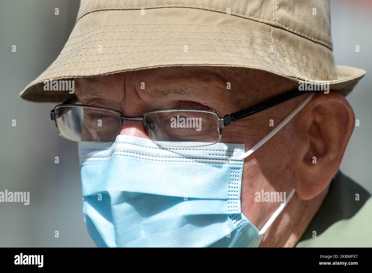 A man wears a protective mask while in a street in Krakow. From today ...