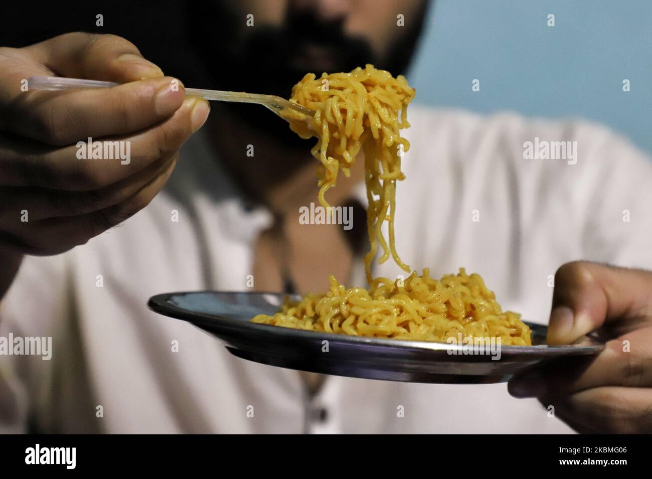 A boy eats Nestle Maggi noodles in New Delhi, India on 15 April 2020 ...