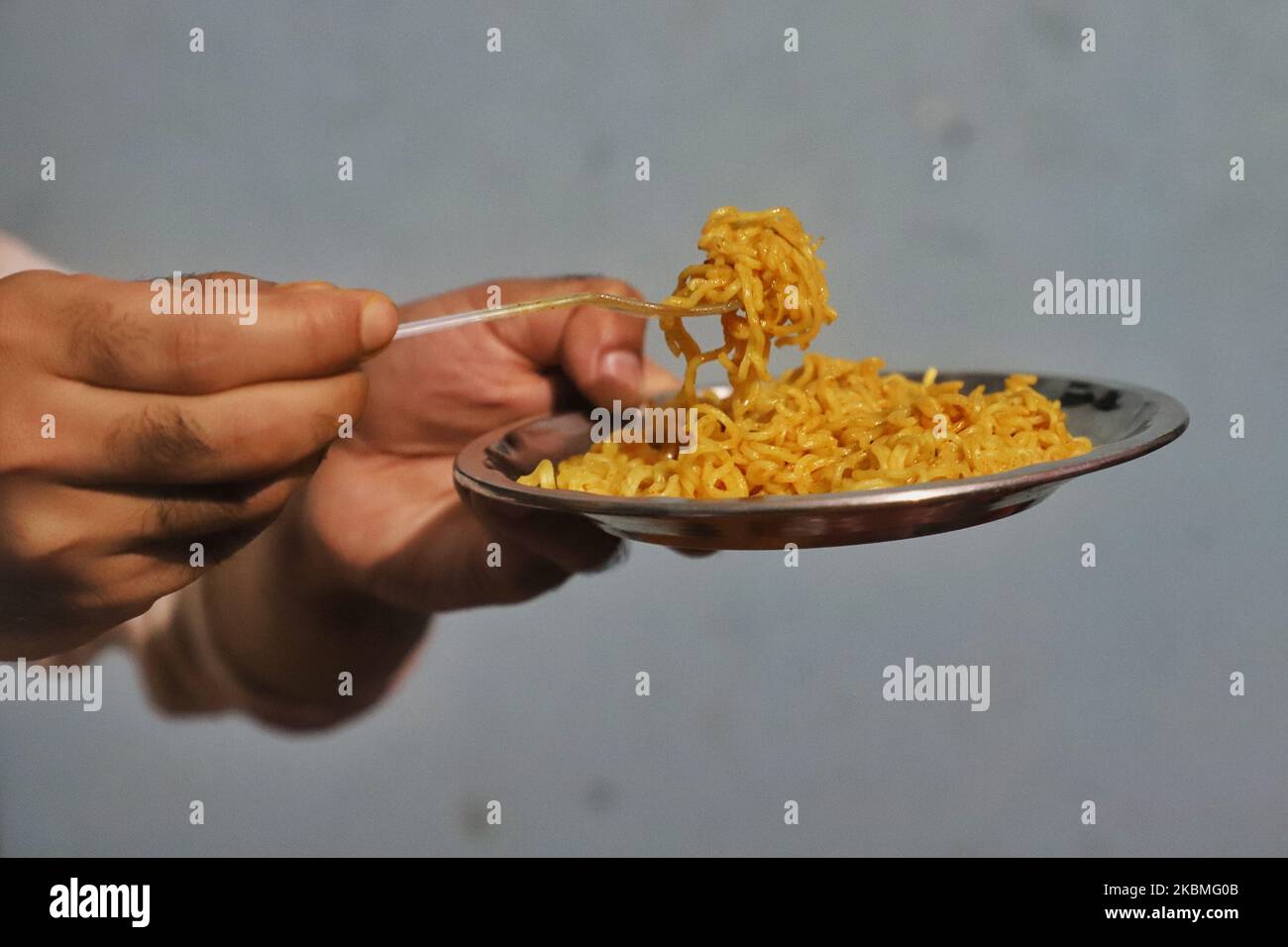 A person shows Nestle Maggi Noodles in a Plate in New Delhi, India on ...