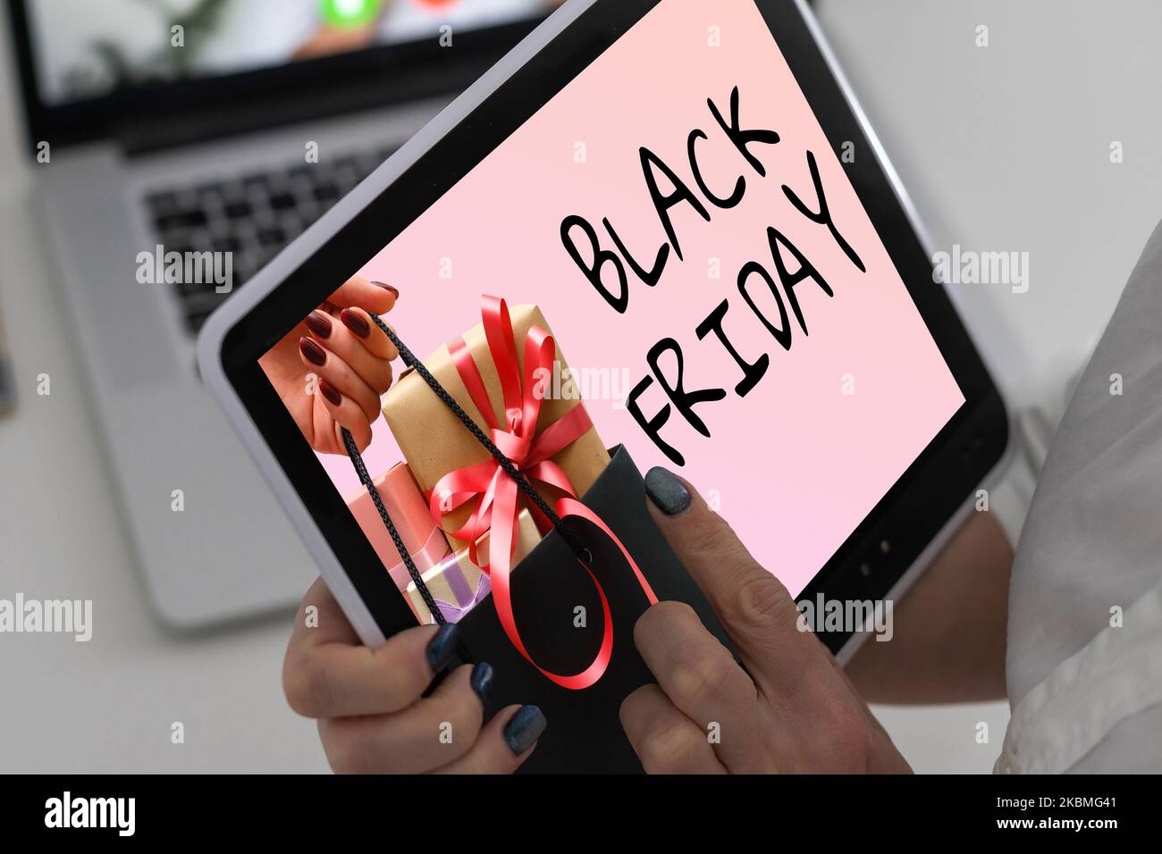 Woman using tablet pc and selecting black friday Stock Photo - Alamy