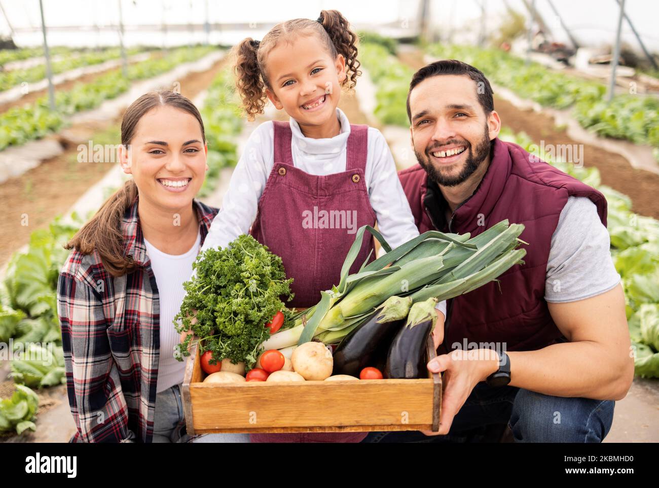 Family, farming and greenhouse portrait with vegetable container for ...