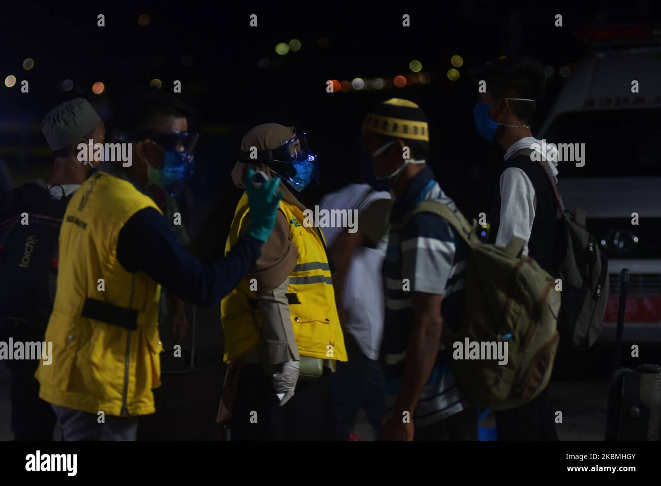 Health quarantine officers inspect ship passengers from the island of ...