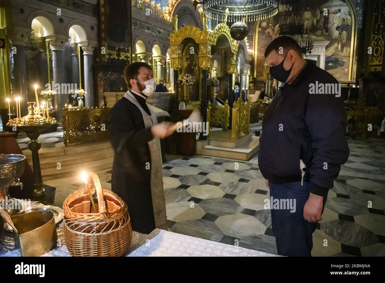 Orthodox priest sprinkles holy water hi-res stock photography and ...