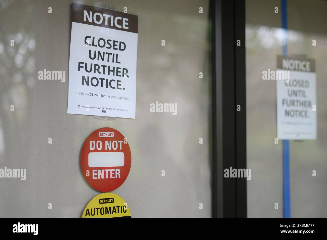 Sings posted on the window of the Fine Wine and Good Spirits store in ...