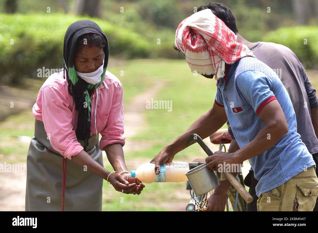 Tea plantation worker wash her hand before picks leave during a nationwide lockdown in the wake ...