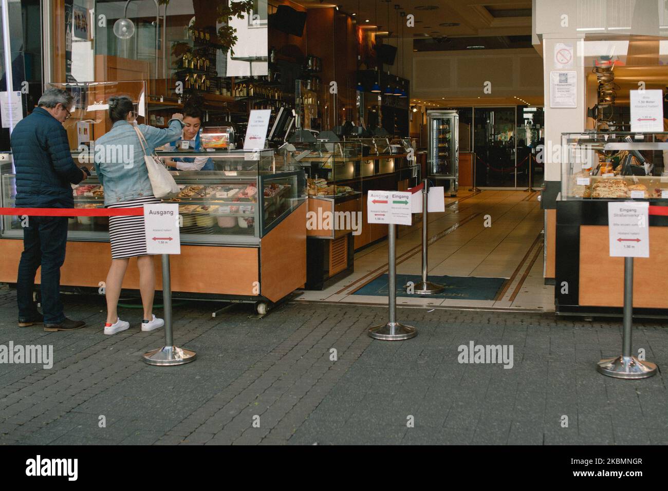 Waiting signs are placed in front of a bakery store on the first day of ...