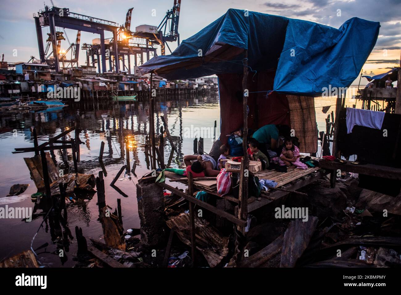 A family rests on their house razed by a fire in Manila, Philippines on ...