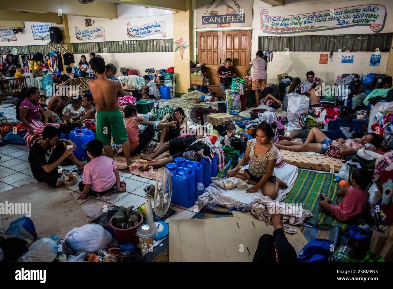 Residents take shelter in a crowded school that serves as an evacuation ...