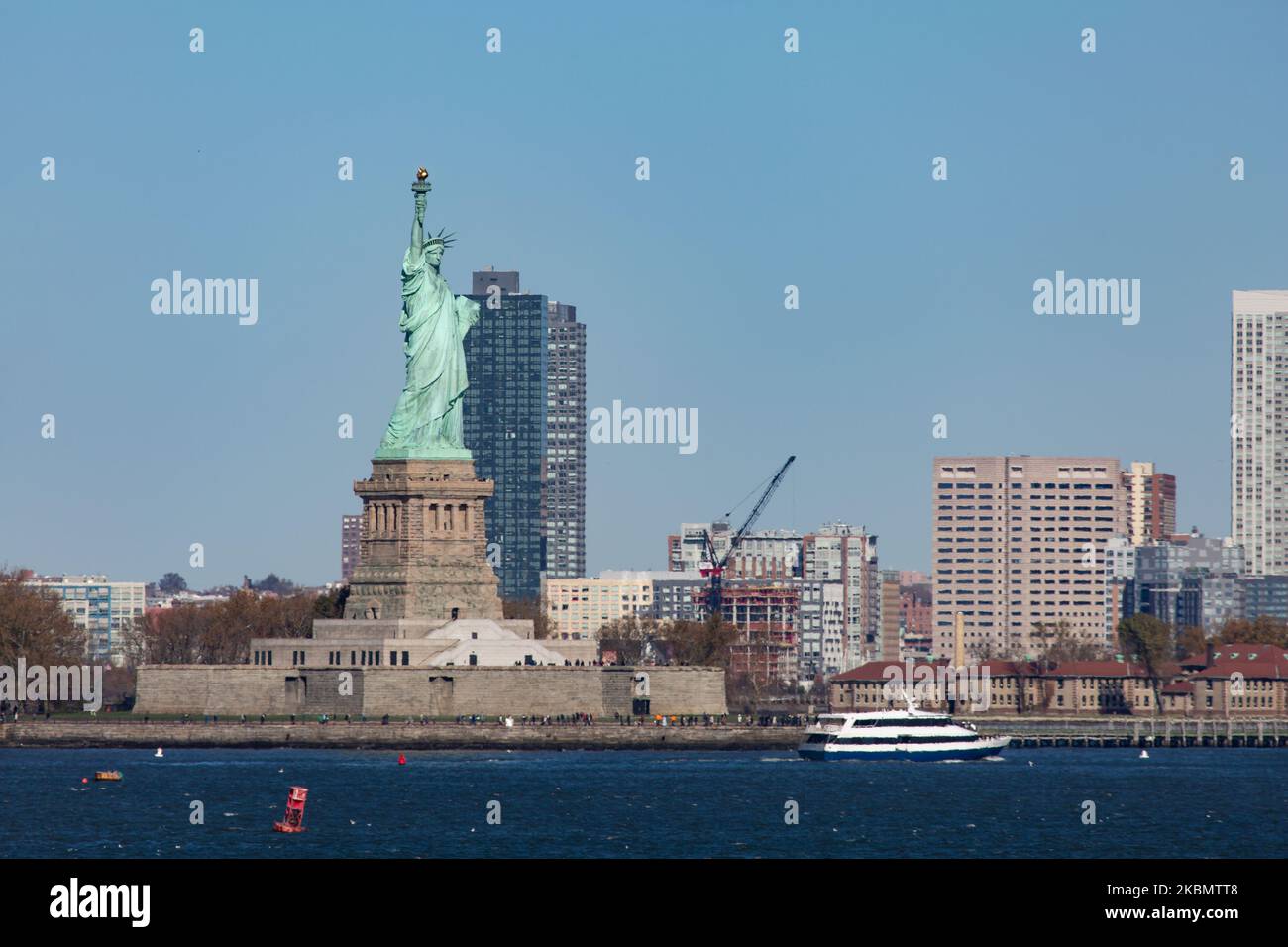 Statue of Liberty as seen during a blue sky cloudless day with tourists ...