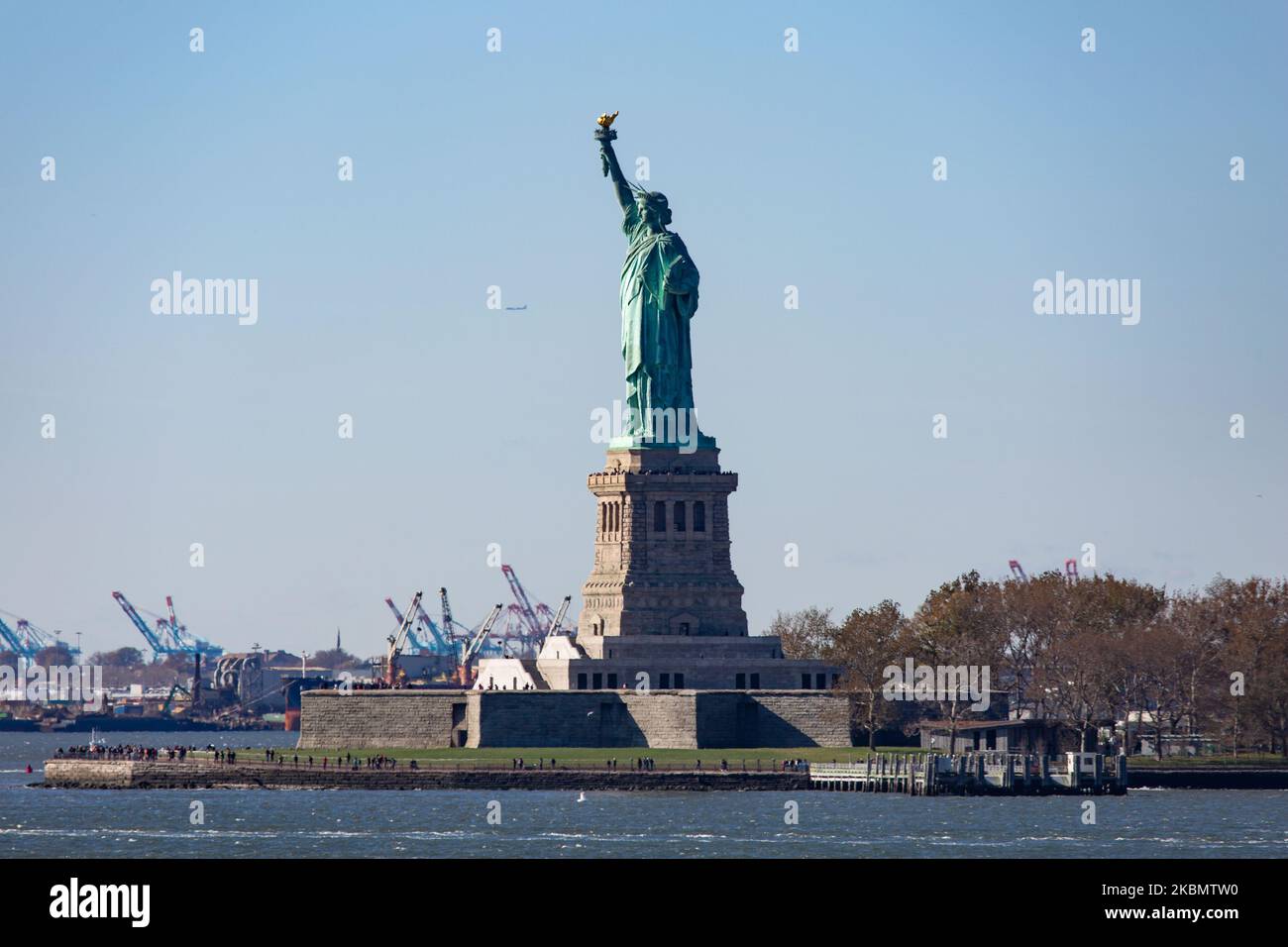 Statue of Liberty as seen during a blue sky cloudless day with tourists ...