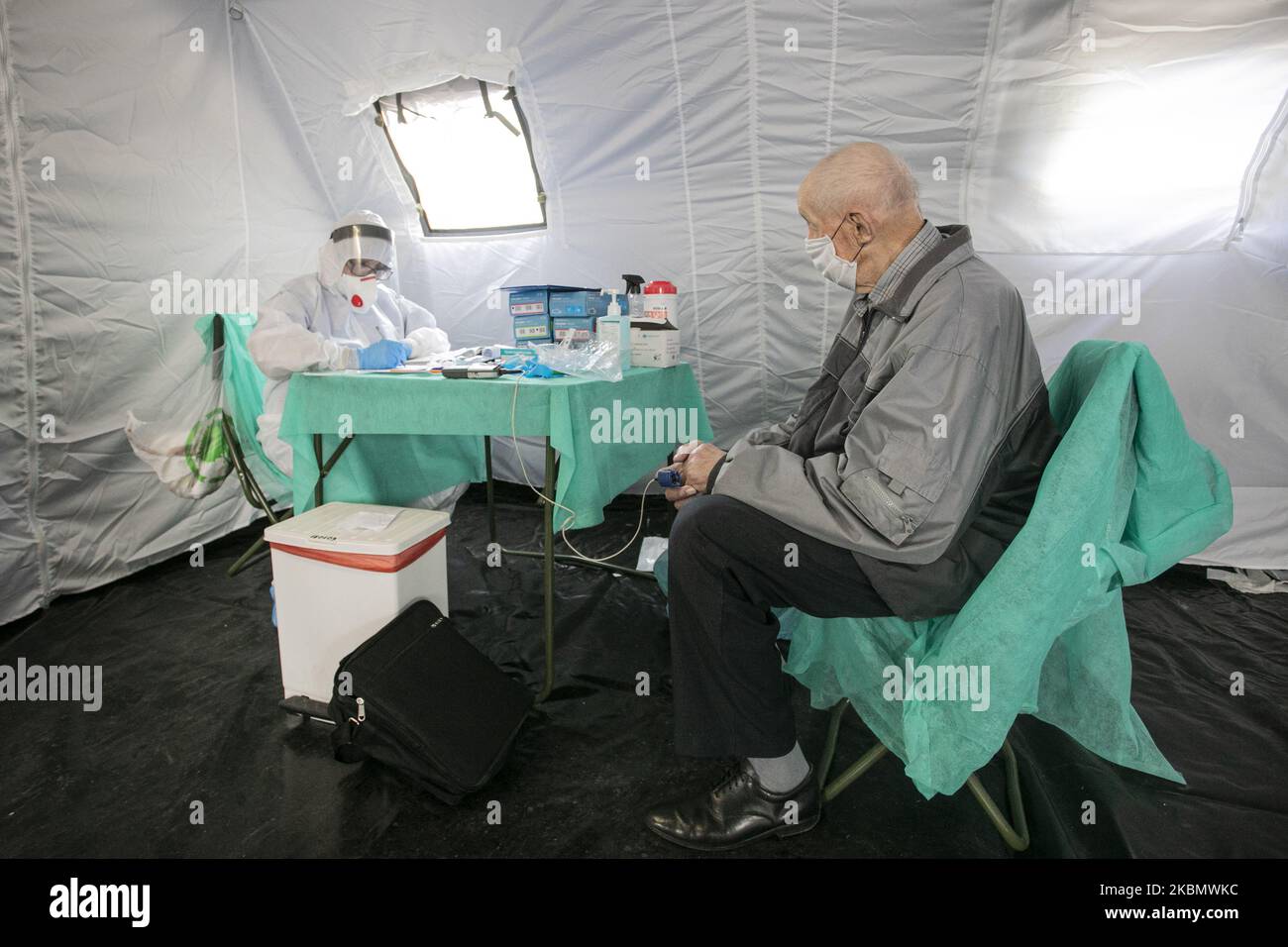 Medical worker wearing protective suit in front of a field emergency ...