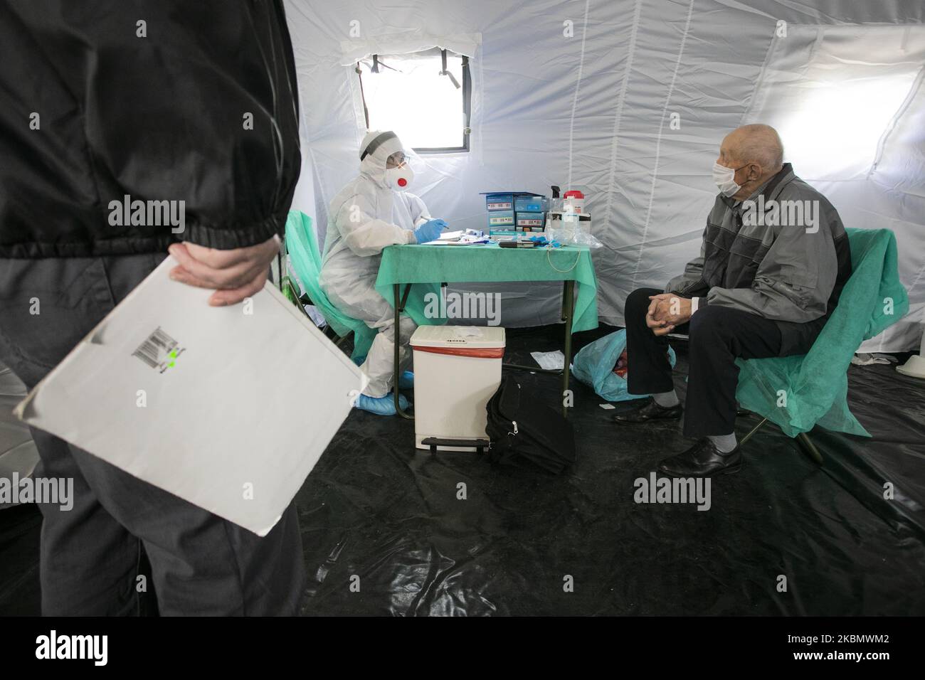 Medical worker wearing protective suit in front of a field emergency ...