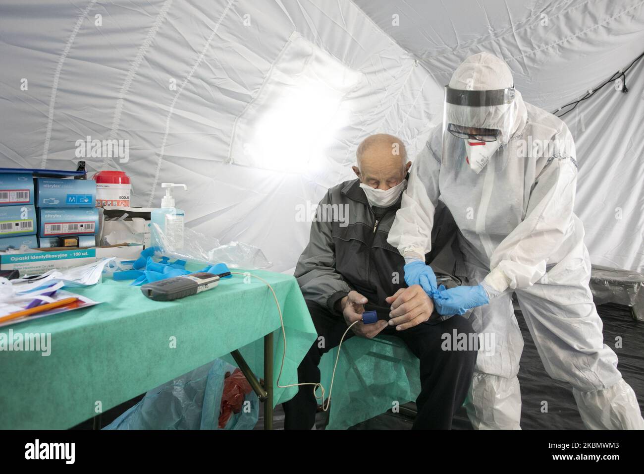 Medical worker wearing protective suit in front of a field emergency ...