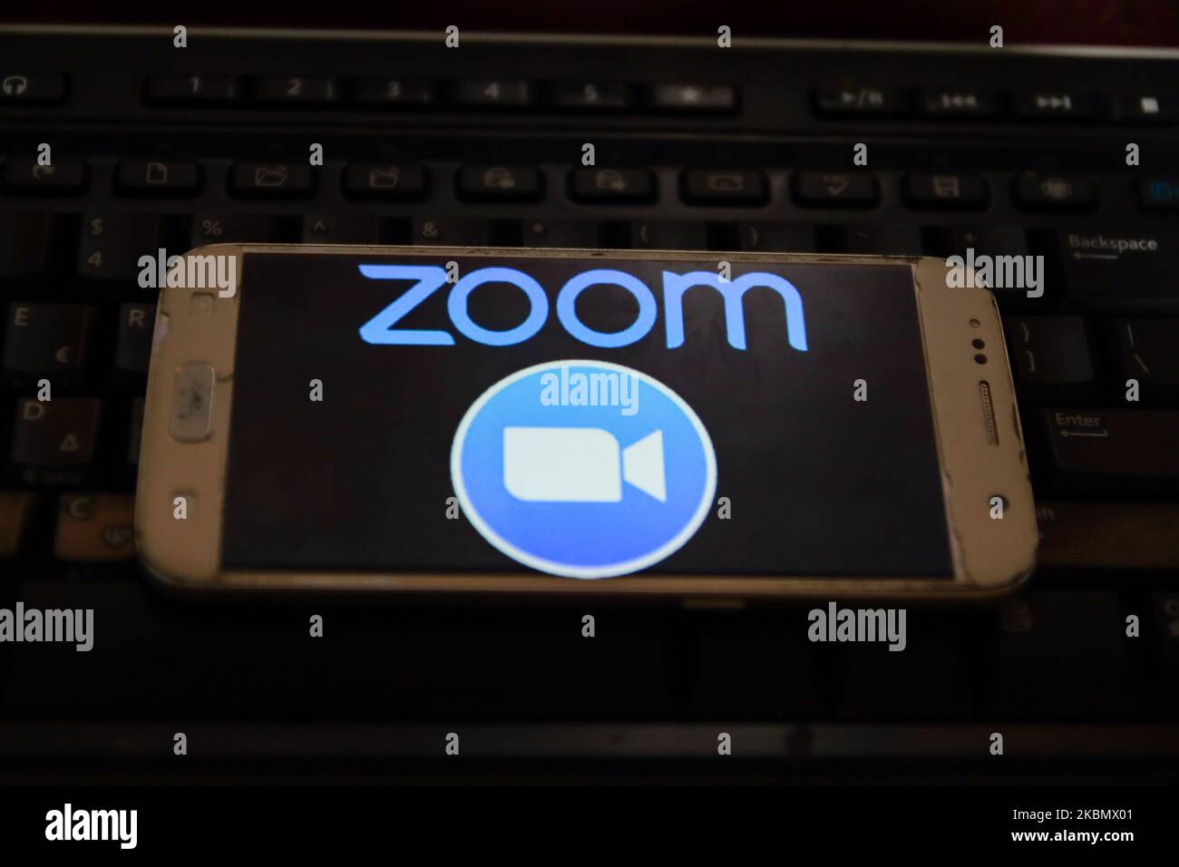 ZOOM Video Communications logo displayed on a phone screen, thumbnails ...