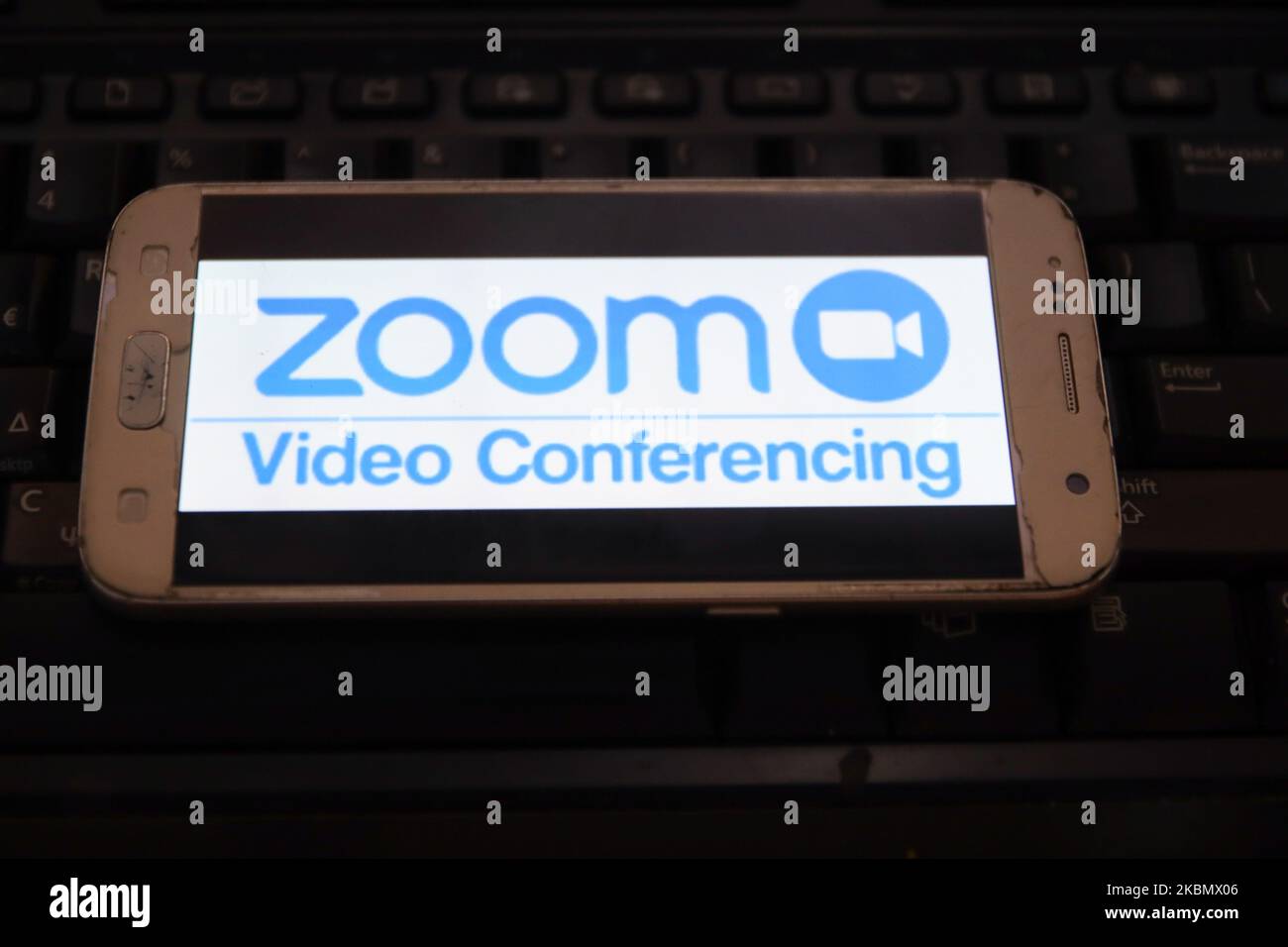 ZOOM Video Communications logo displayed on a phone screen, thumbnails ...