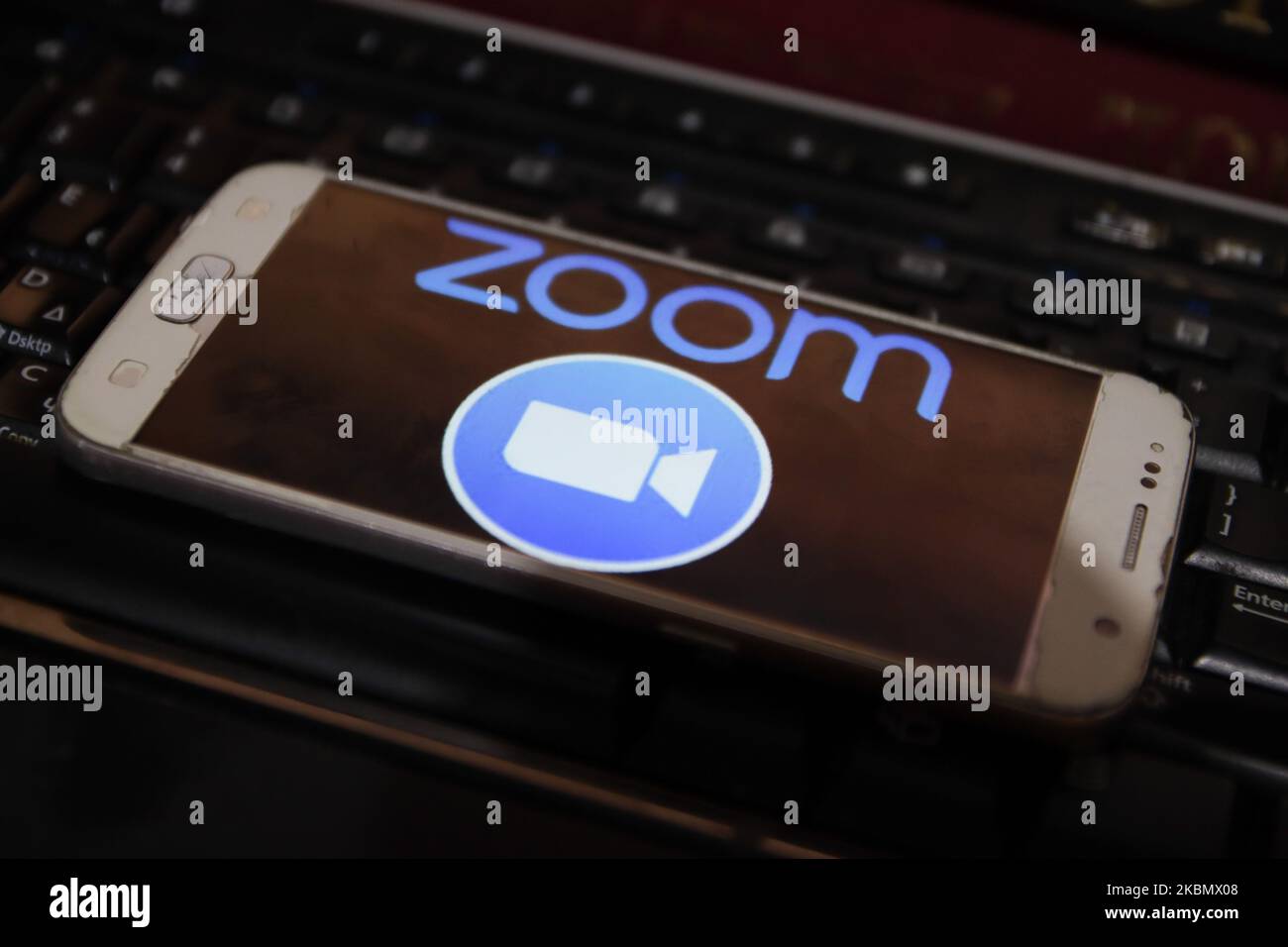 ZOOM Video Communications logo displayed on a phone screen, thumbnails ...